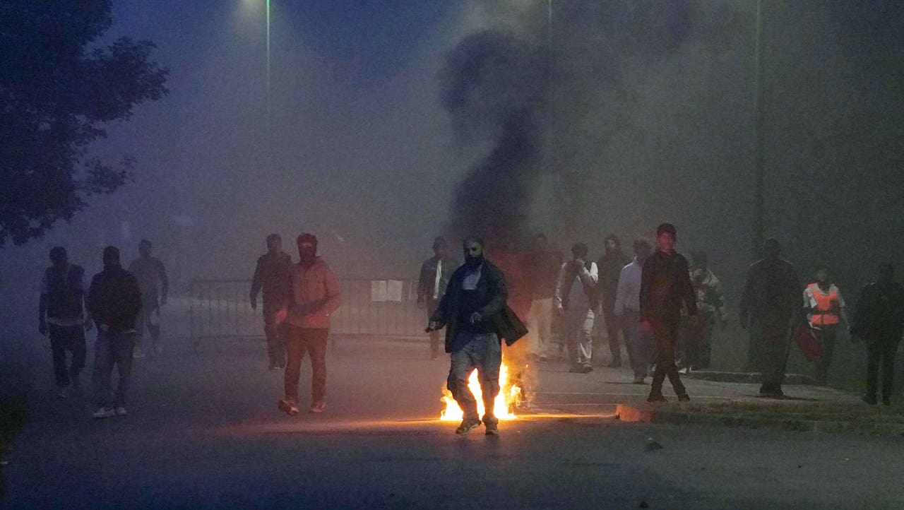 French riot police in early morning clash with migrants in coastal town ...