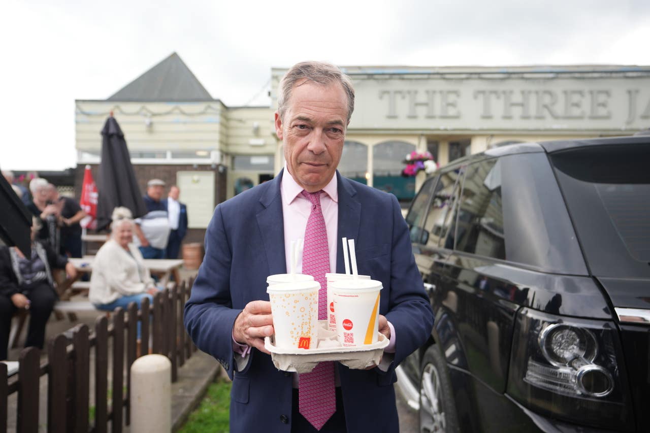 Woman arrested after Nigel Farage doused with milkshake outside pub ...