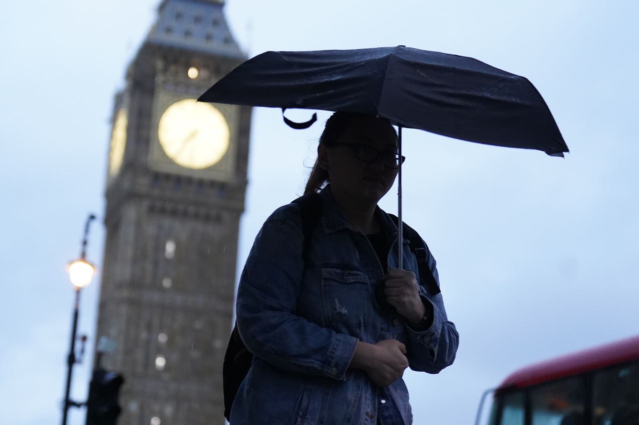 In pictures: ‘Atrocious’ weather as band of rain travels across the UK