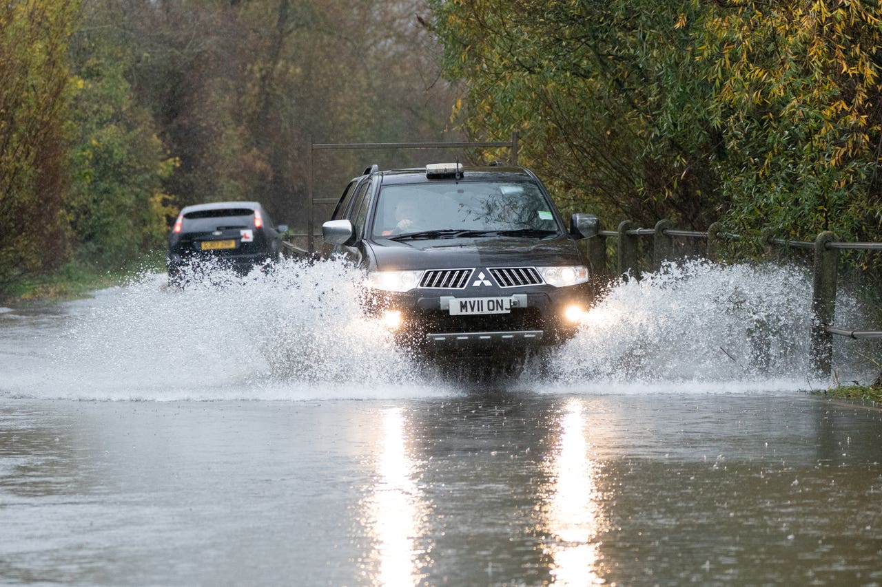 In pictures: ‘Atrocious’ weather as band of rain travels across the UK