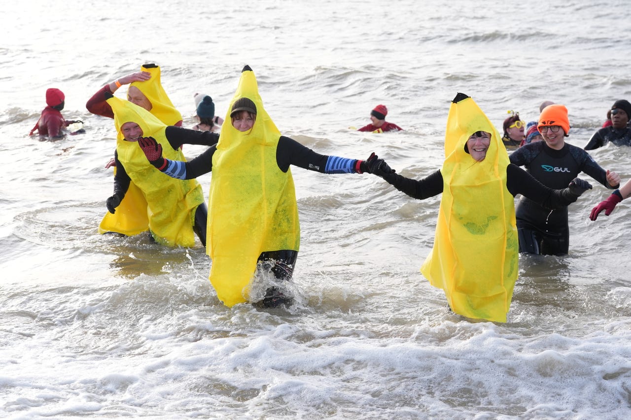 In Pictures: Cold water courage to start the new year as swimmers dive ...