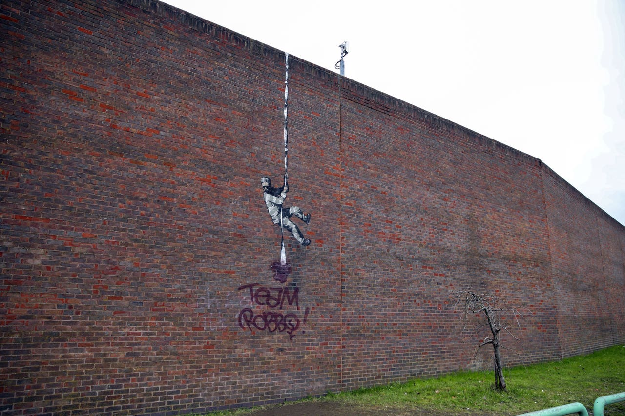 Banksy artwork on side of Reading Prison defaced with rival’s name ...