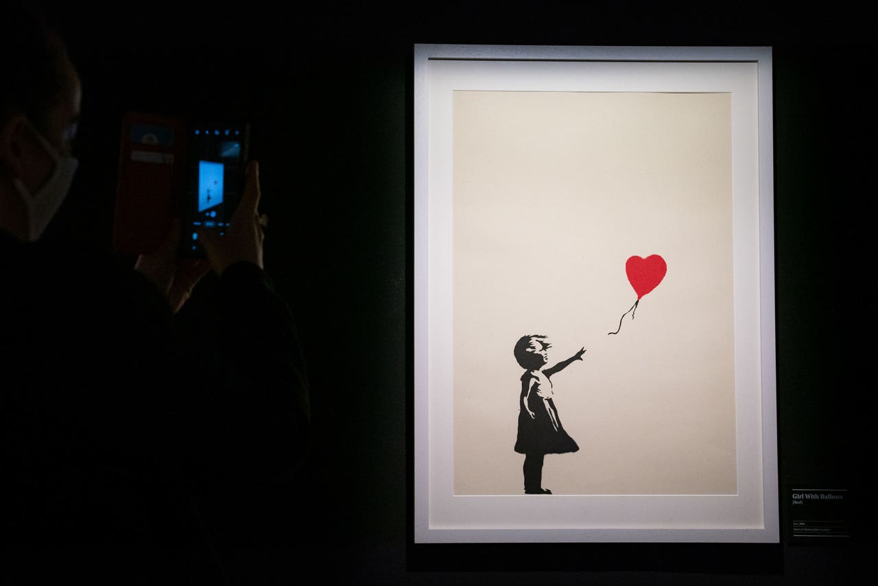 Banksy artwork which partially shredded itself goes back under the ...